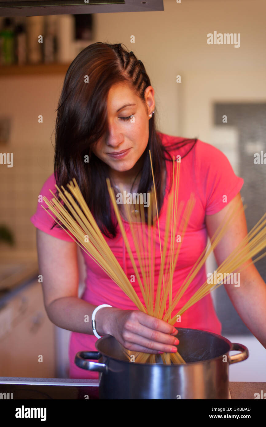 happy woman cooking spaghetti Stock Photo - Alamy