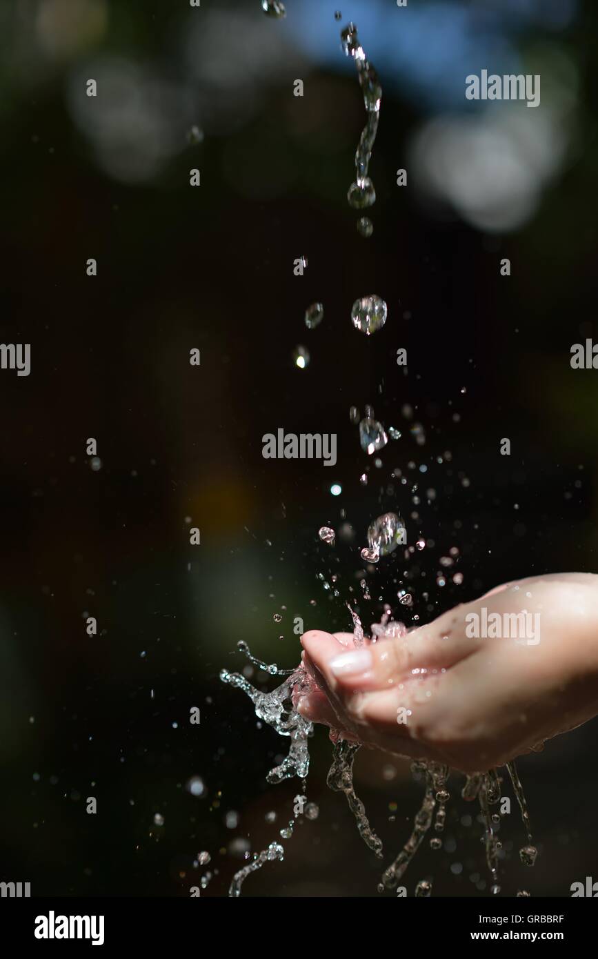 water stream on woman hand Stock Photo - Alamy