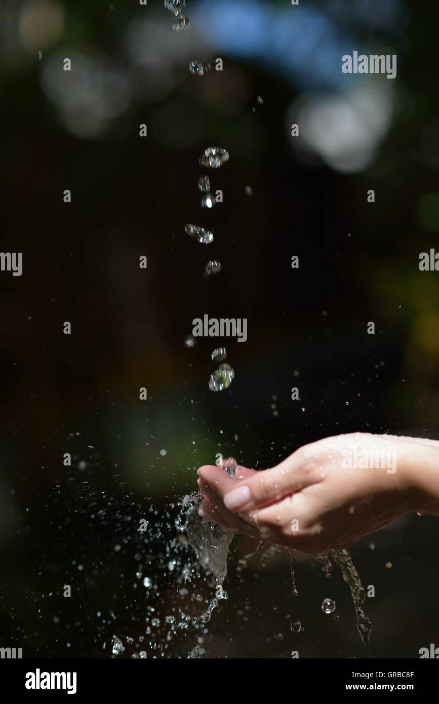 water stream on woman hand Stock Photo - Alamy