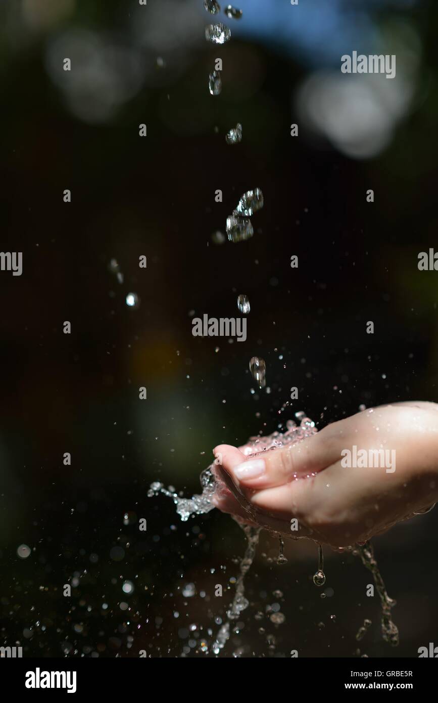 water stream on woman hand Stock Photo - Alamy