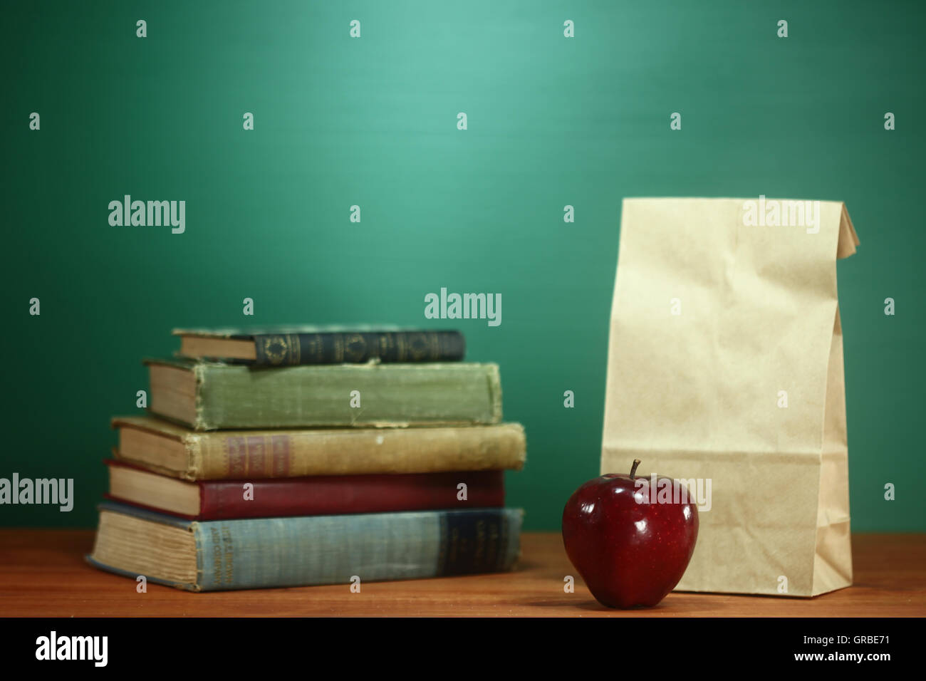 Books, Apple and Lunch on Teacher Desk Stock Photo - Alamy