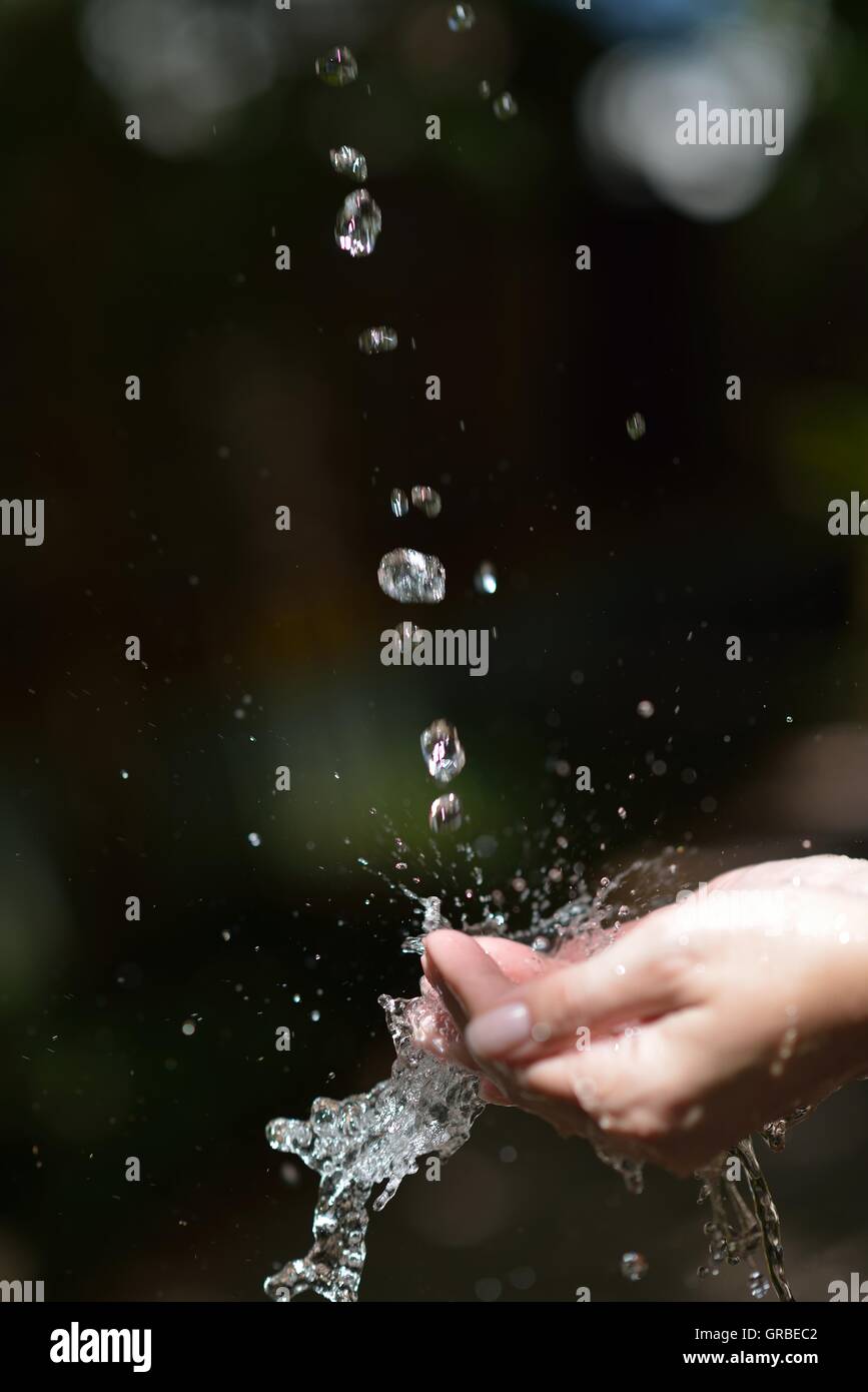 water stream on woman hand Stock Photo - Alamy