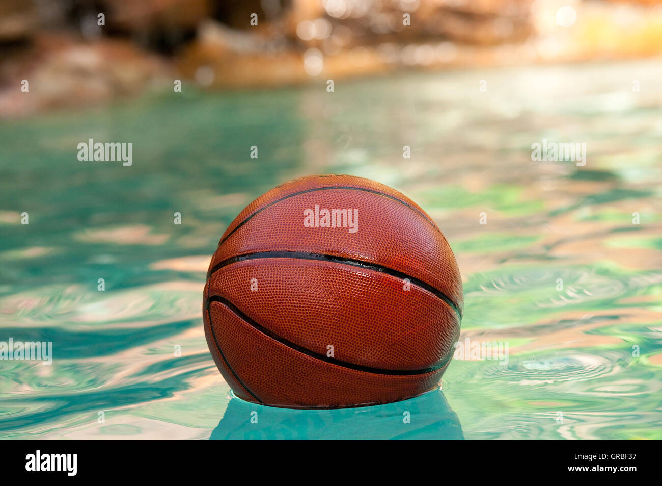 Basketball in pool Stock Photo - Alamy