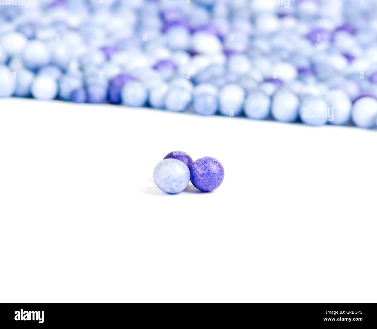 One blue and two violet little pearls Stock Photo - Alamy