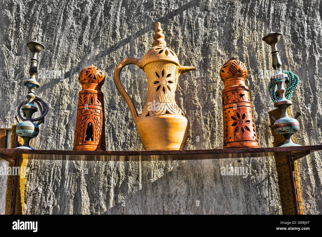 Eastern pitchers stand on a shelf Stock Photo - Alamy