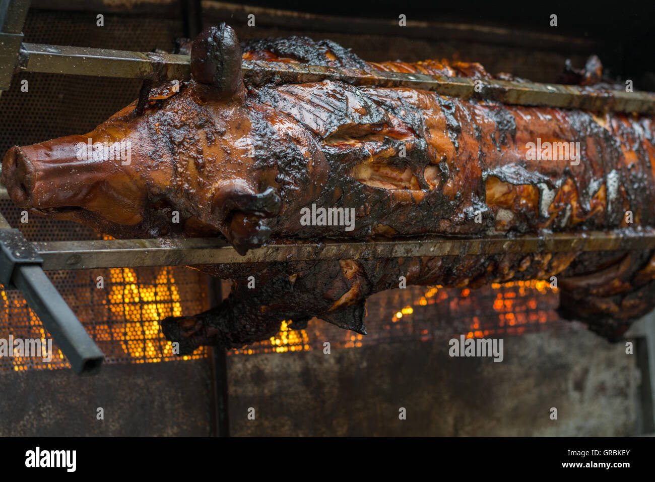 Crispy Suckling Pig On A Rotisserie Stock Photo - Alamy