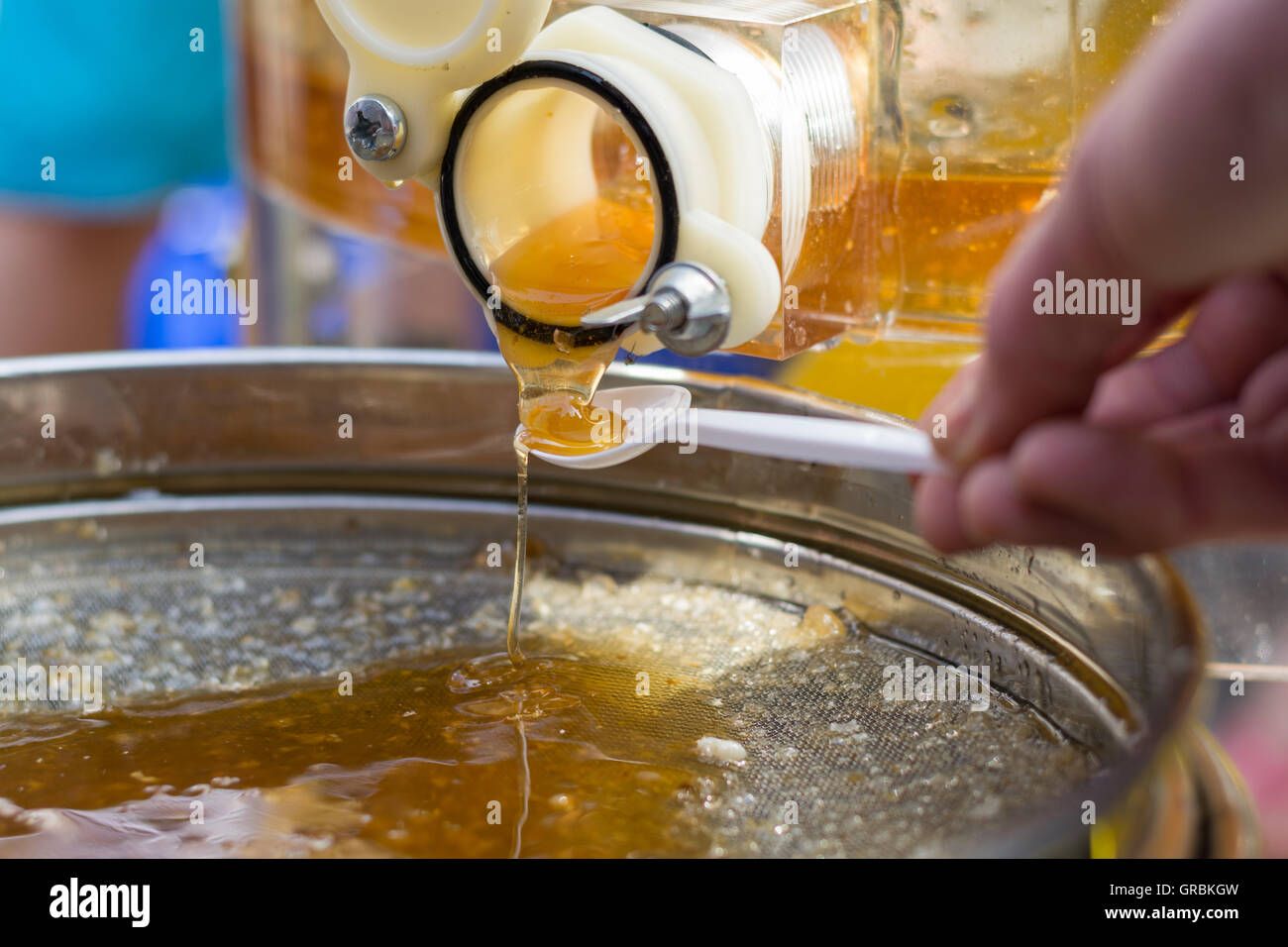 Honey Flows From Honey Extractor Through Sieve Stock Photo - Alamy