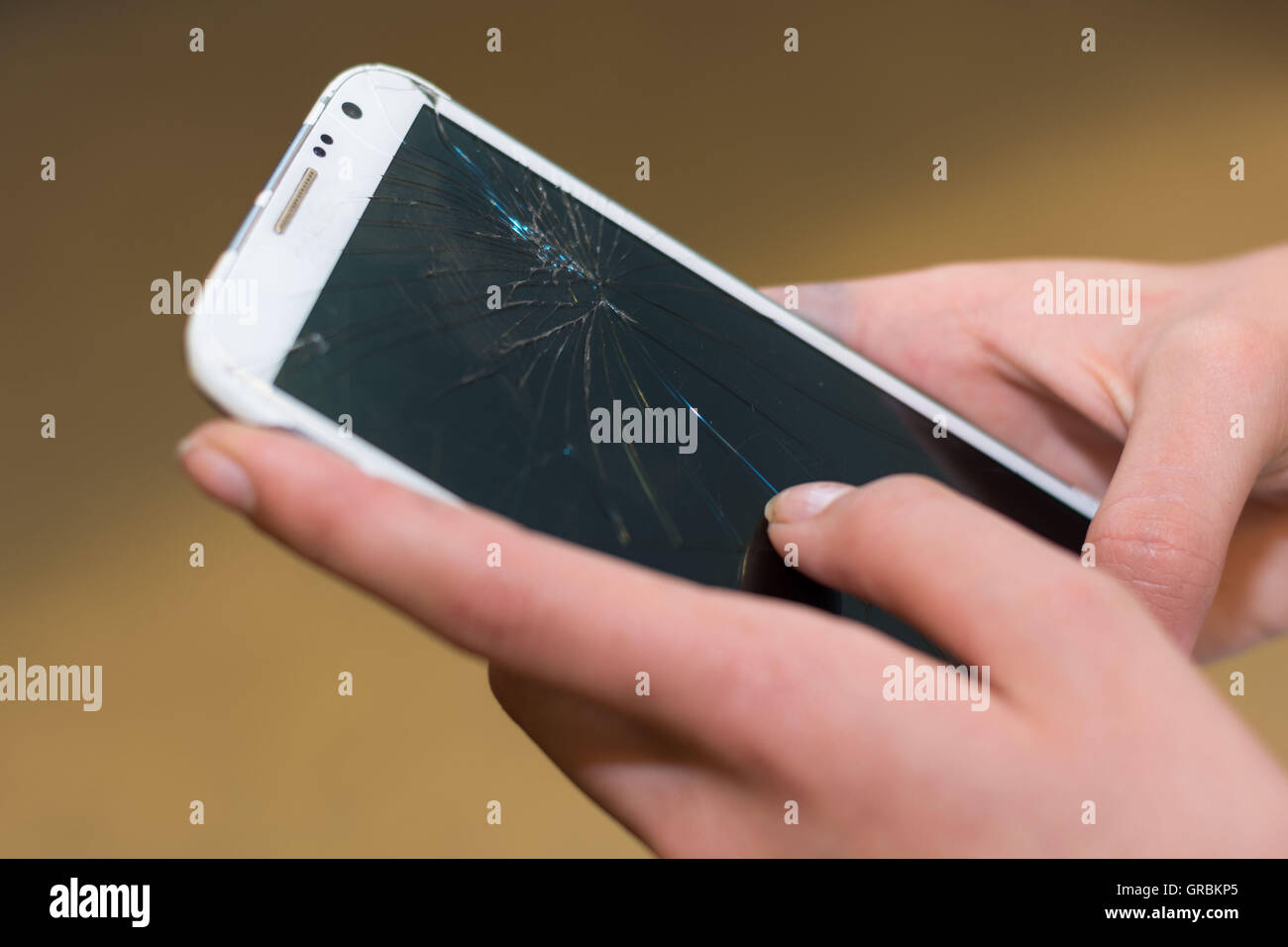 Hand Holding Smart Phone With A Broken Screen Stock Photo - Alamy