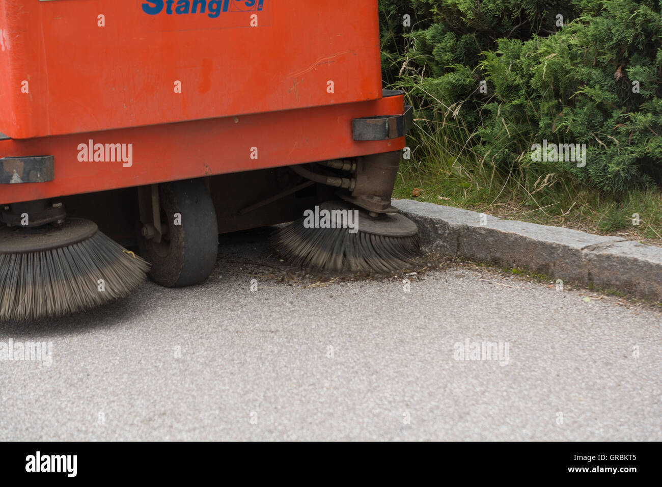 Sidewalk Is Cleaned With Street Sweeper Stock Photo - Alamy