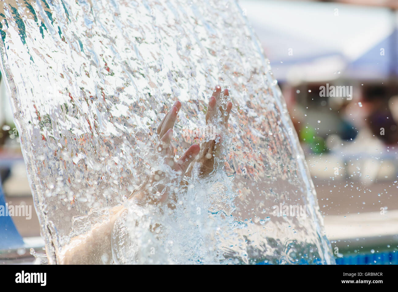 Child catching falling water hands hi-res stock photography and images ...