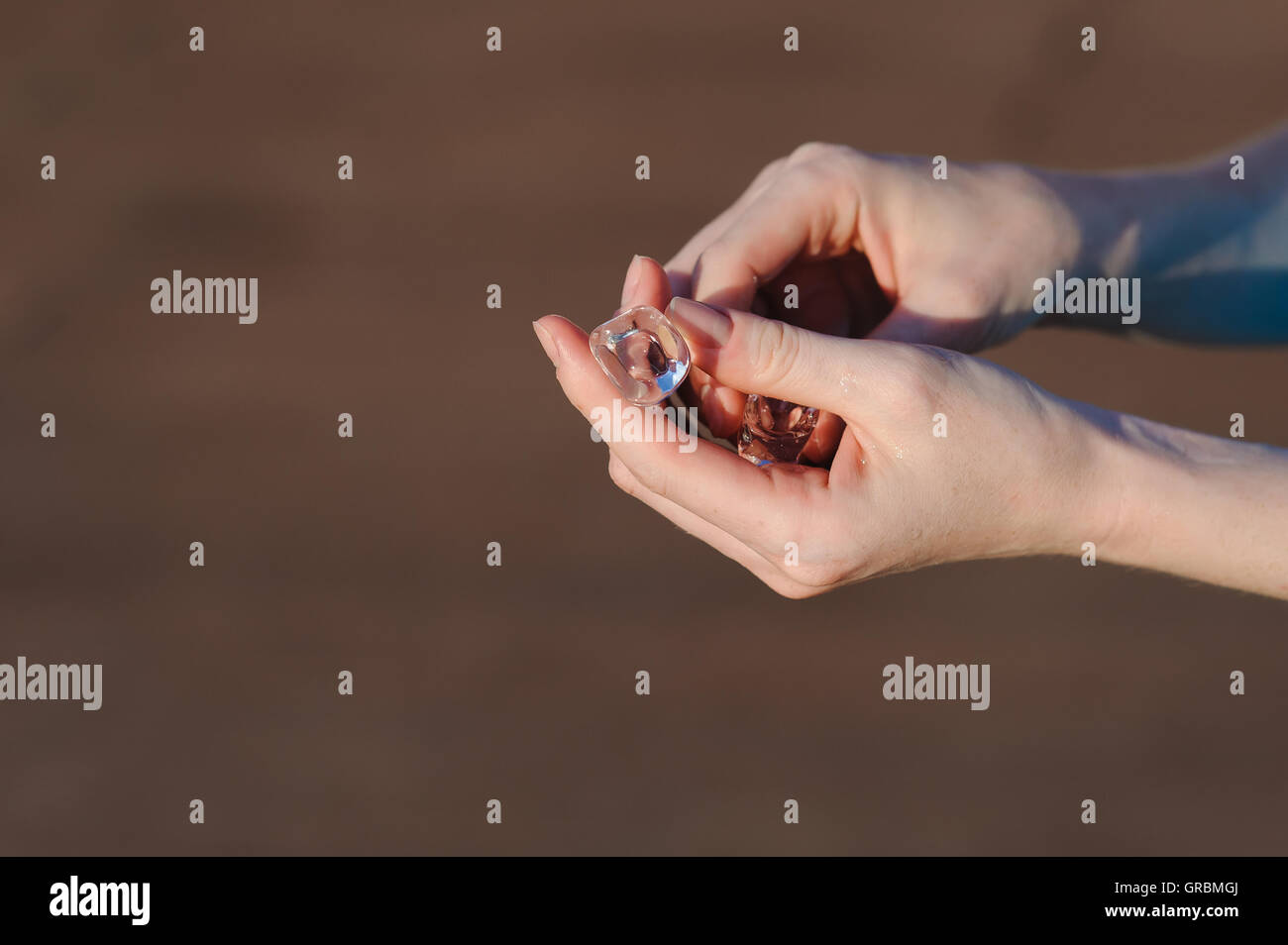 Melting ice cube hand hi-res stock photography and images - Alamy