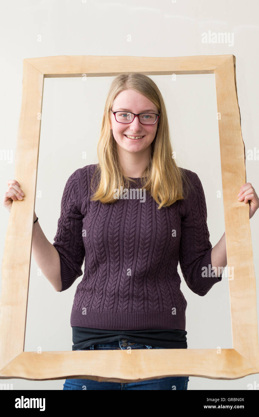 Girl Smiling From A Large Wooden Frame Stock Photo - Alamy
