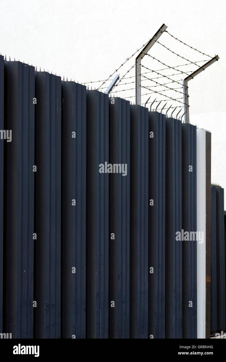 Fence With Barbed Wire On Top Stock Photo - Alamy