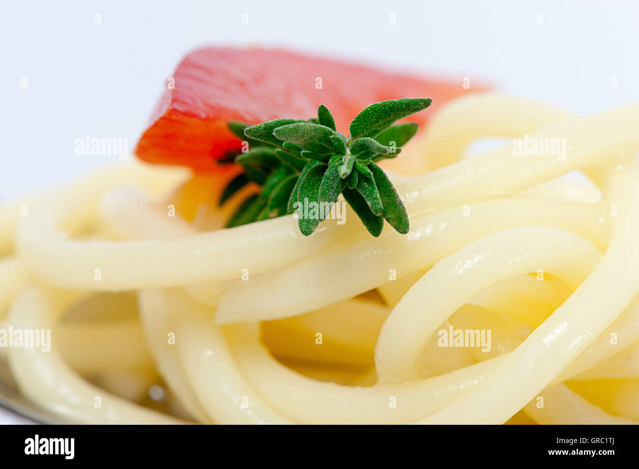 Spaghetti Pasta Decorated With Tomato And Rosemary Stock Photo - Alamy