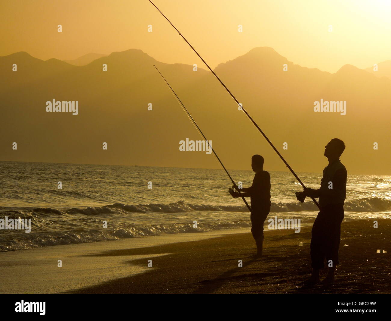Fishing At Sunset Stock Photo - Alamy