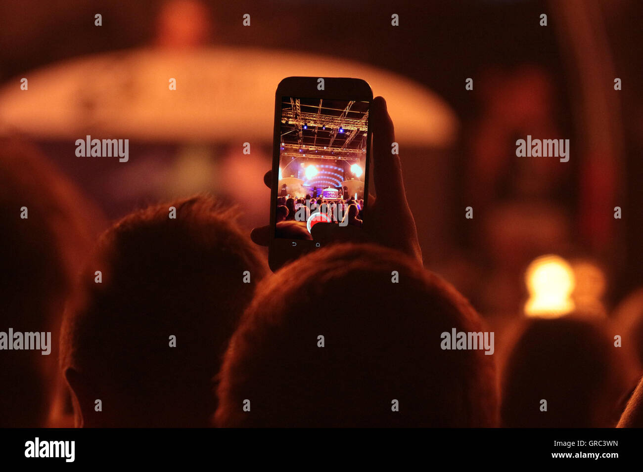 Filming at concert hi-res stock photography and images - Alamy