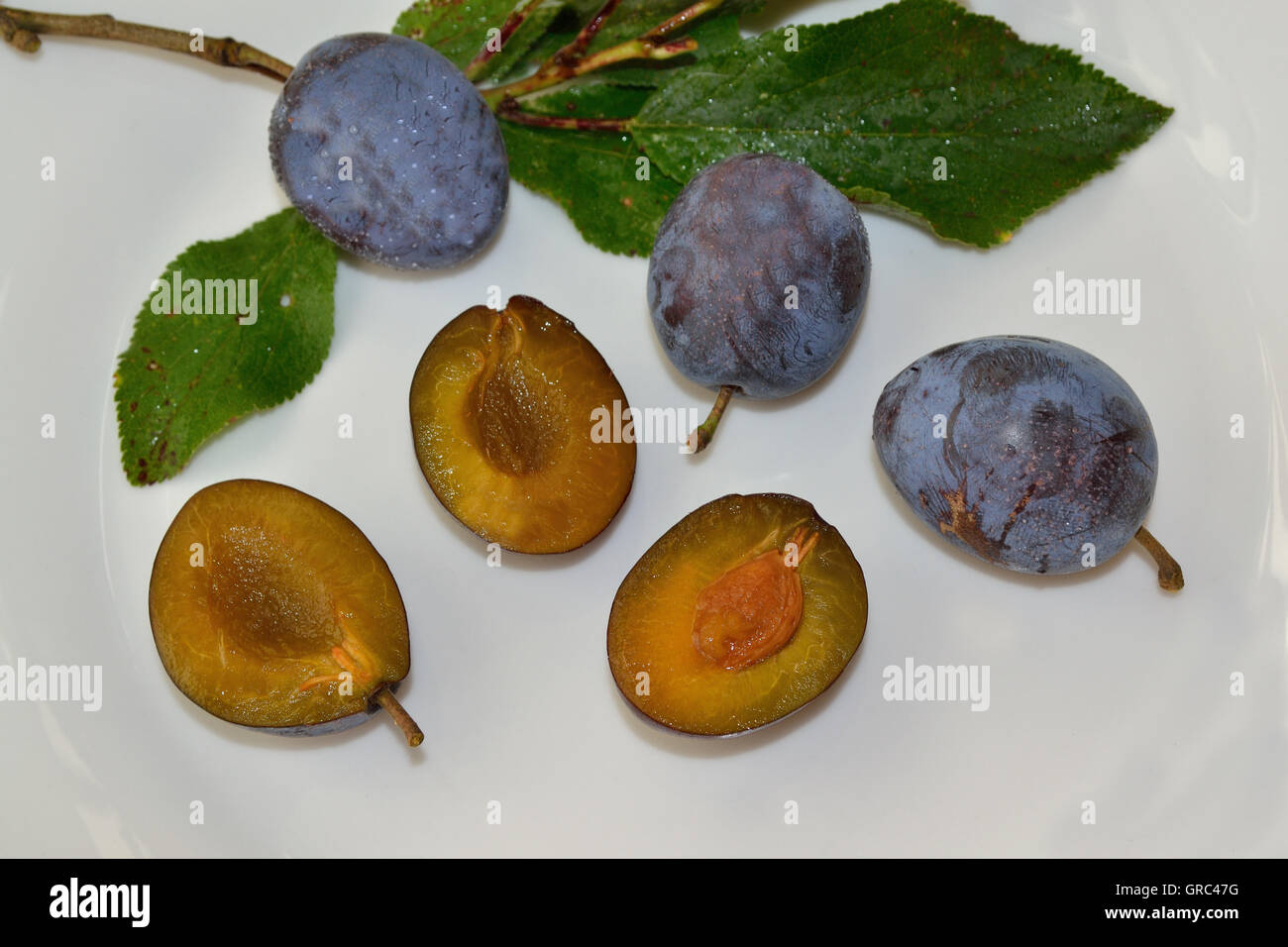 Some Large Plums, Some Halved Stock Photo - Alamy