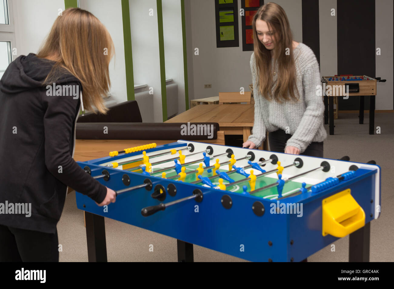 Two Teenage Girls Playing Table Football Stock Photo - Alamy