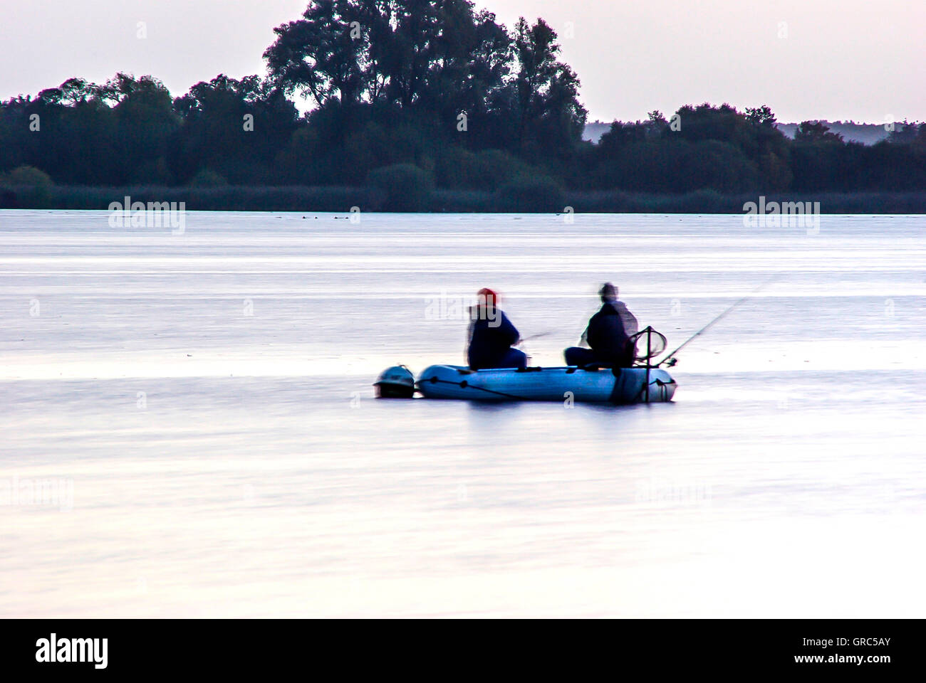 Angler Angling In The Boat Stock Photo - Alamy