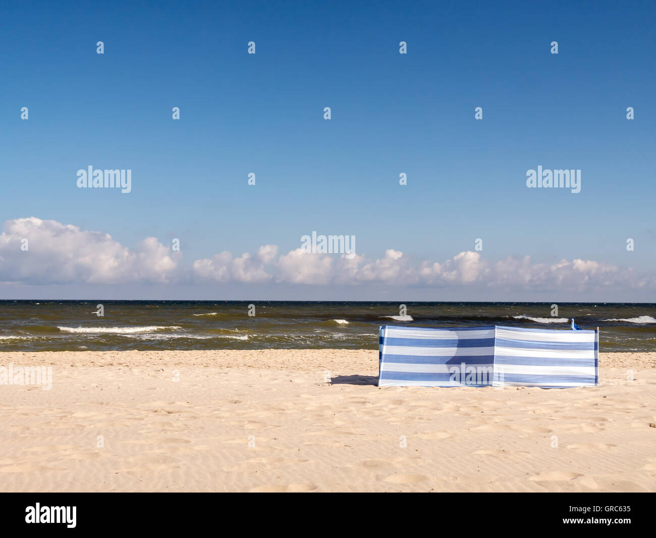 White and blue striped windbreak at the beach Stock Photo - Alamy