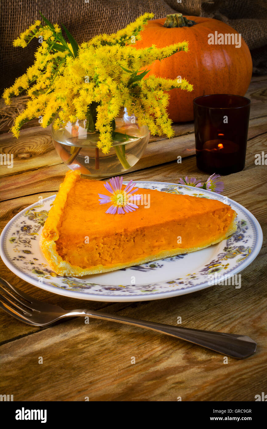 Pumpkin pie slice on the rustic wooden table. Traditional Thanksgiving ...