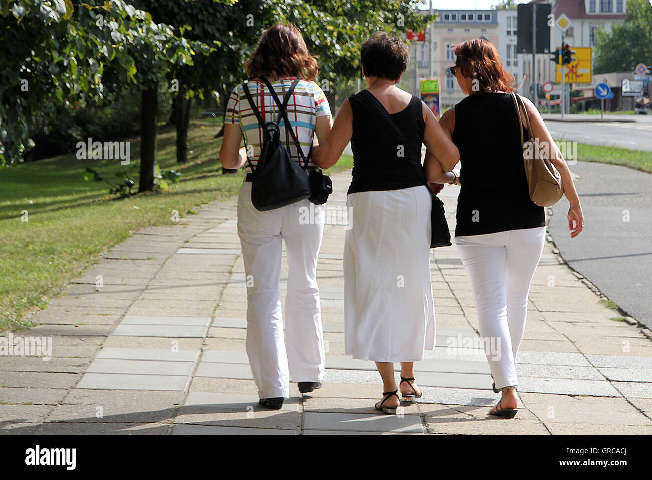 Three Women Walking Stock Photo - Alamy