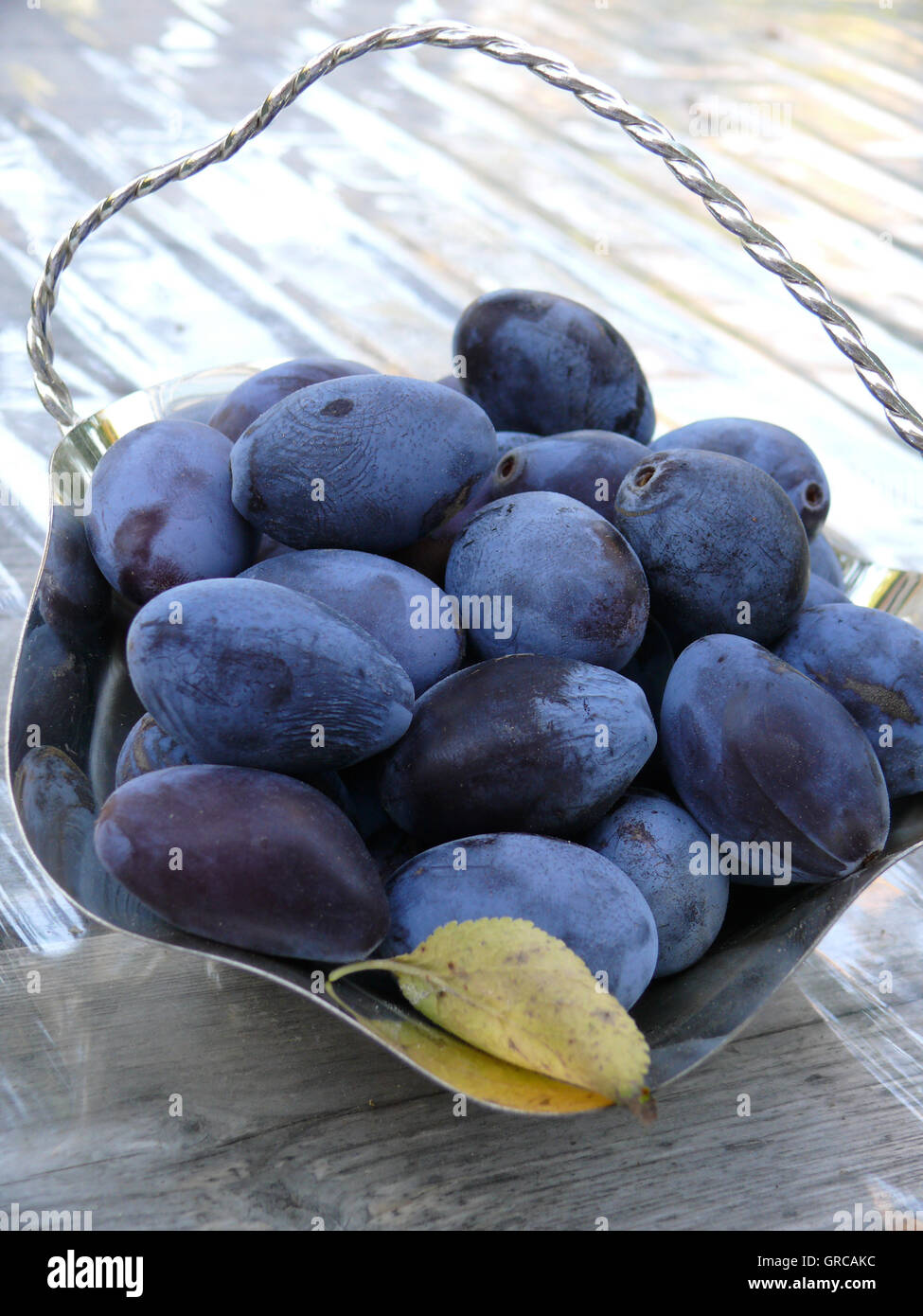 Ripe Blue Plums In A Basket Stock Photo - Alamy