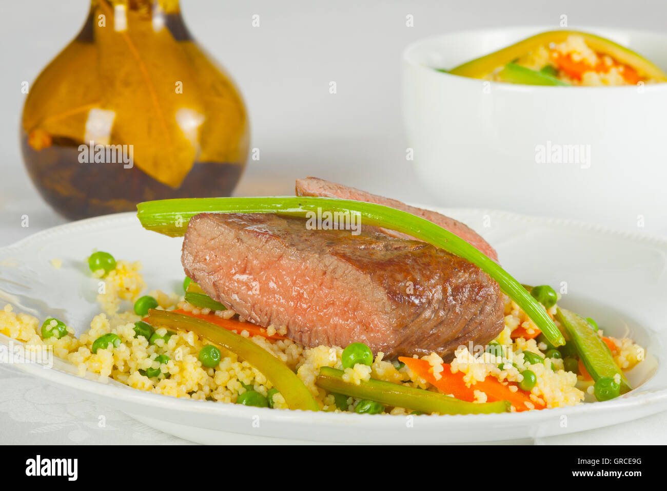 Lamb On Rice With Carrots And Peas Stock Photo - Alamy