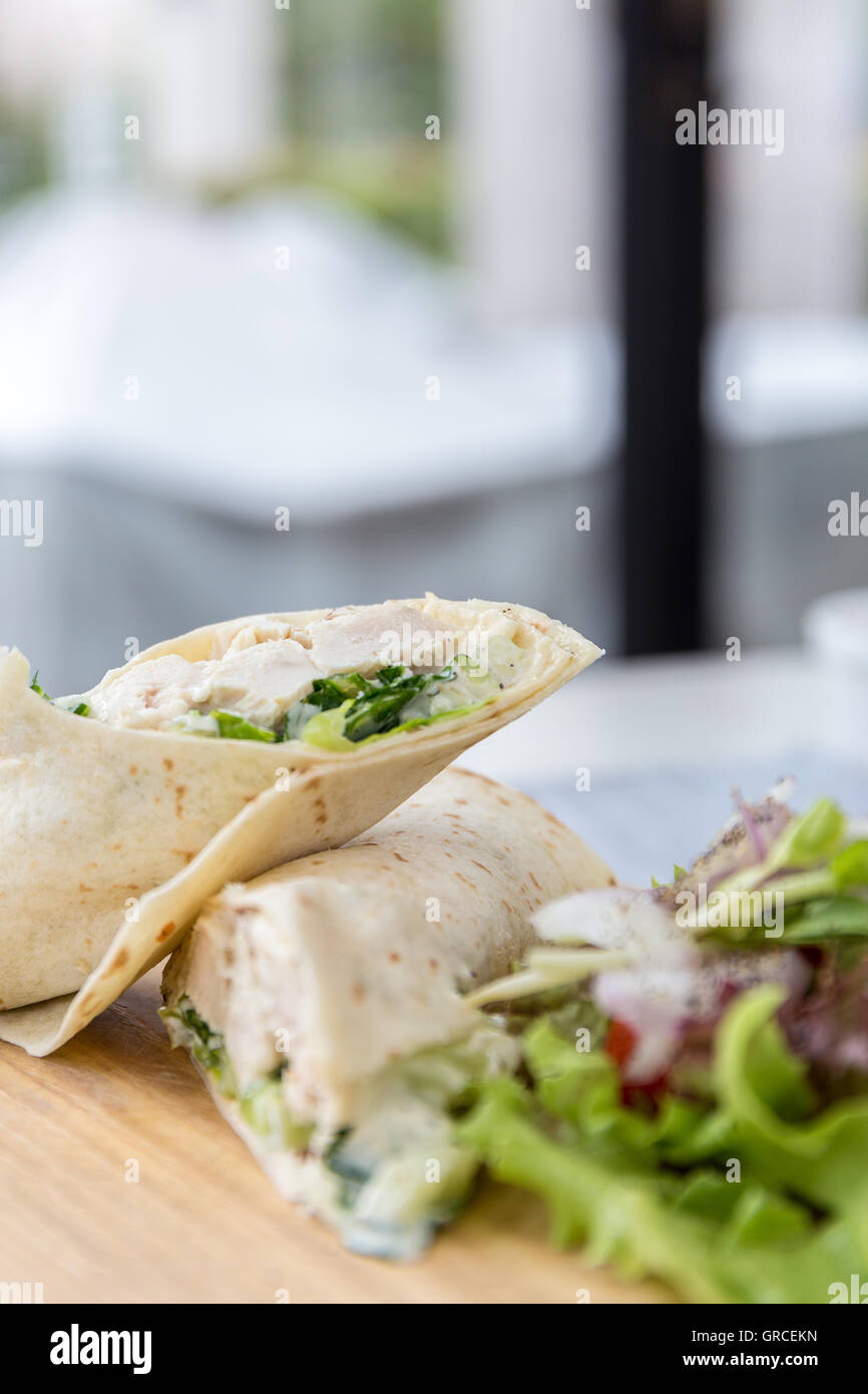 Chicken wrap with fresh vegetable on table Stock Photo - Alamy