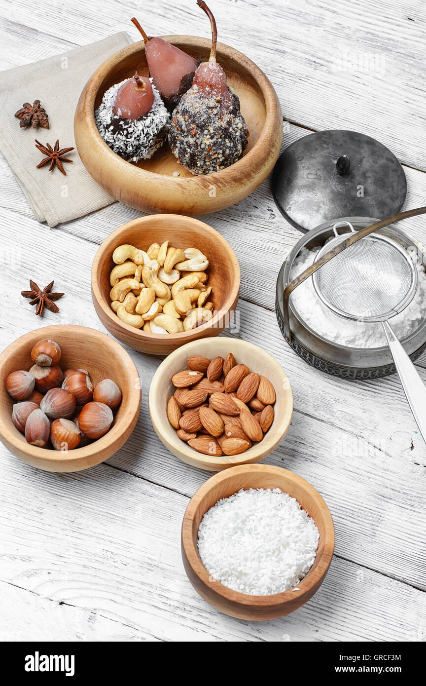 Pears in chocolate-coconut syrup and nuts with almonds Stock Photo - Alamy
