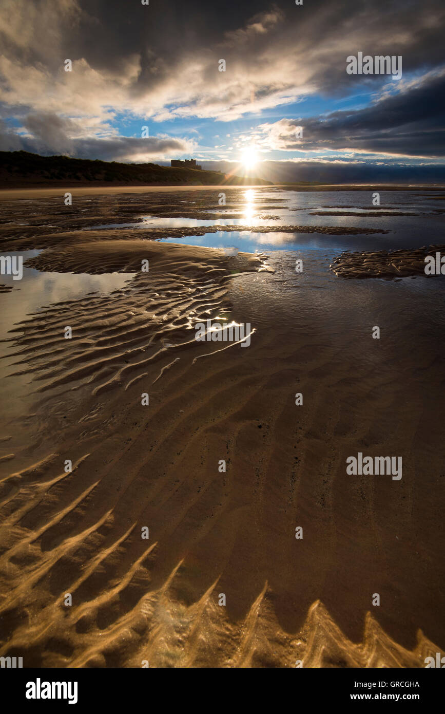 Dramatic sunset light on the beach at Bamburgh, Northumberland England ...