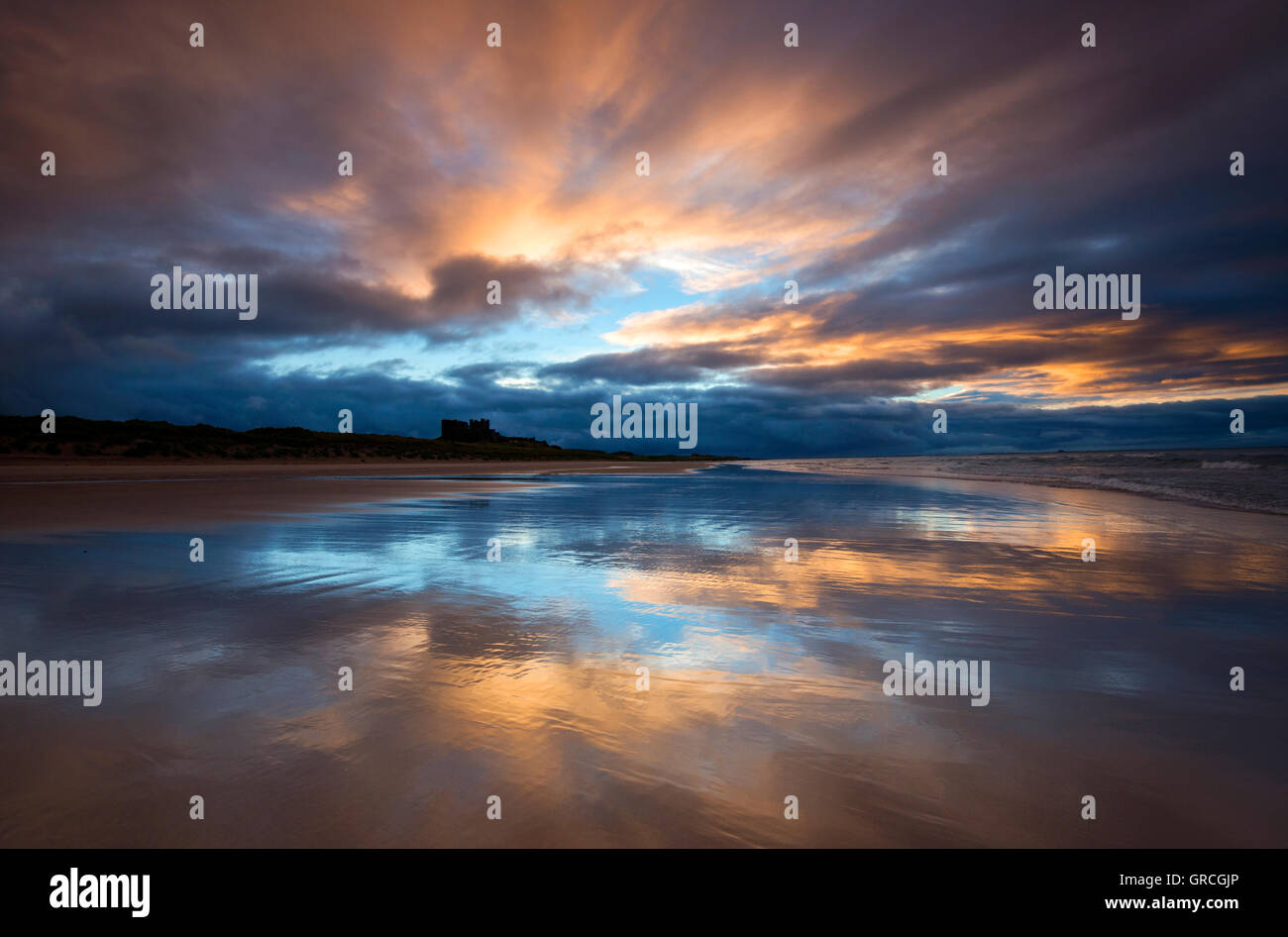 Sunset on the beach at Bamburgh, Northumberland England UK Stock Photo ...