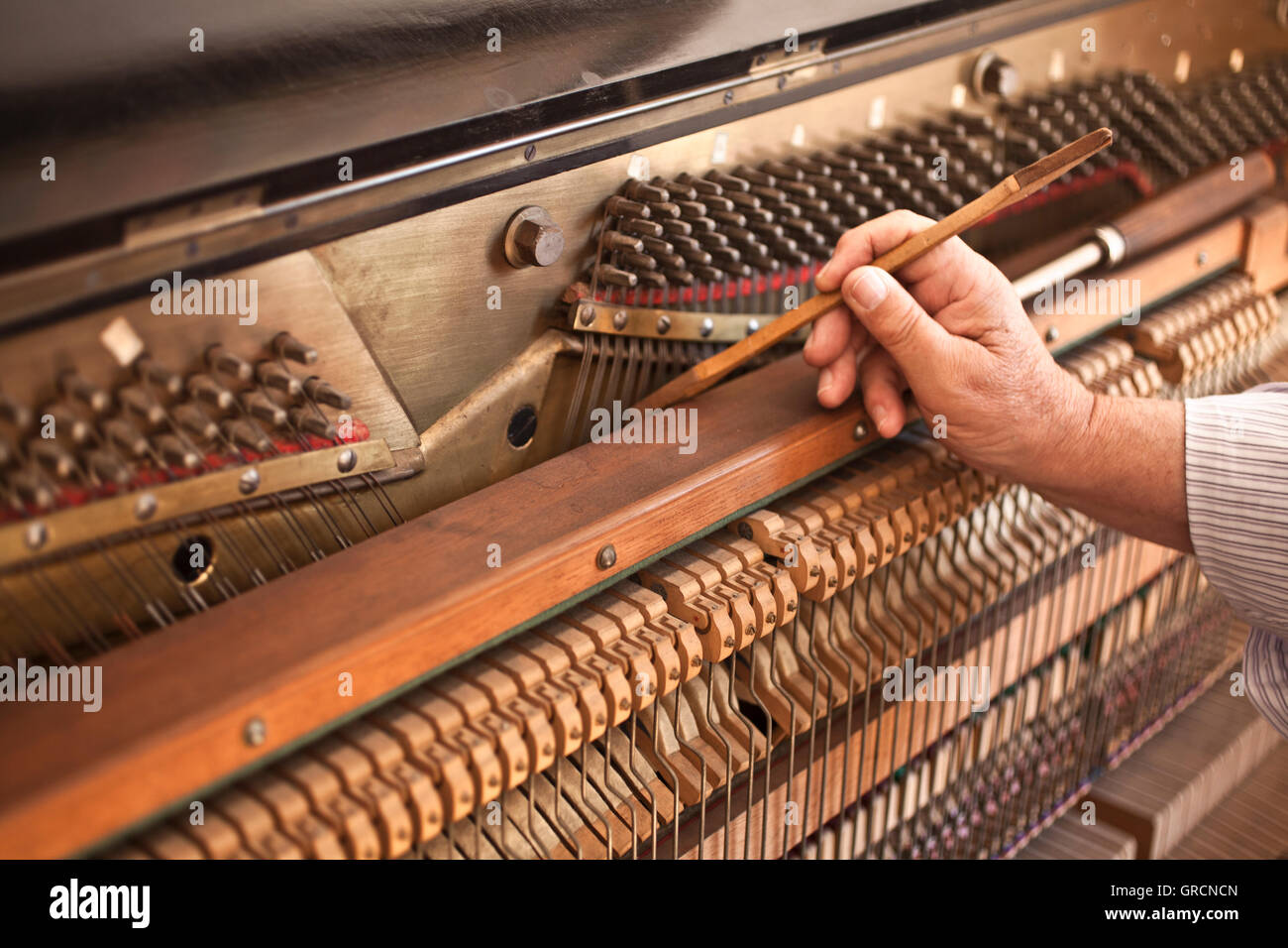 Hand Of A Piano Tuner On An Open Piano Stock Photo - Alamy