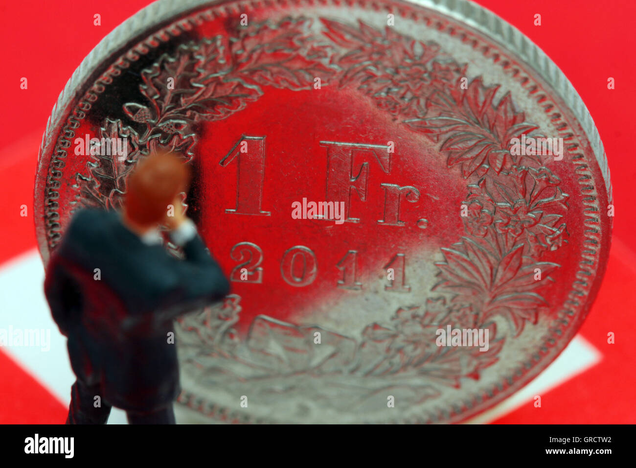 Swiss Franc On Flag Of Switzerland Stock Photo - Alamy