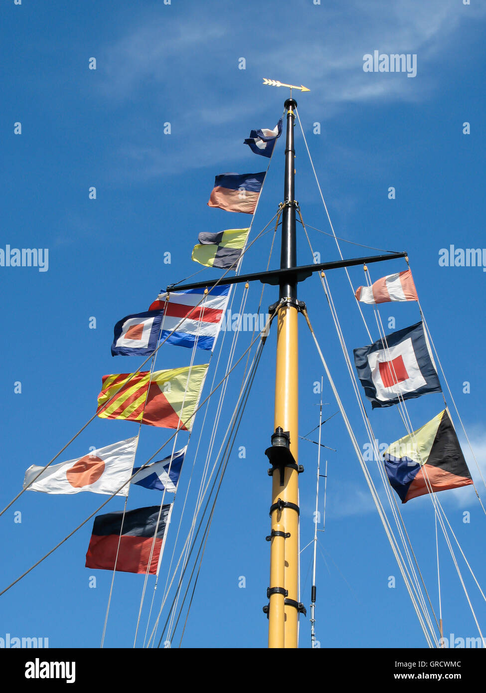 Colored Flags On A Pole In Front Of A Blue Sky Stock Photo - Alamy