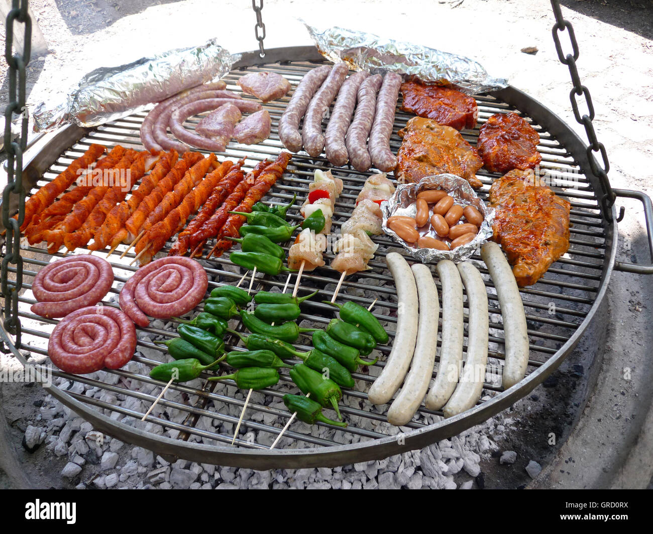 Swing Grill With Sausages, Vegetables And Steaks Stock Photo - Alamy