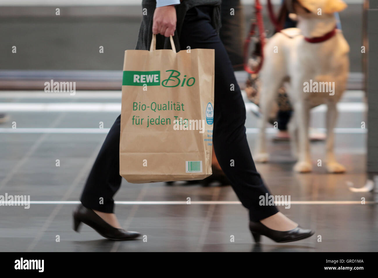 Woman Carrying Paper Bag With Rewe Biological Produces Stock Photo - Alamy