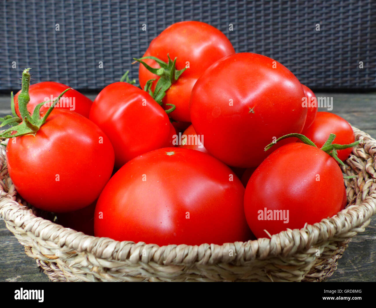 Red Tomatoes In A Basket Stock Photo - Alamy