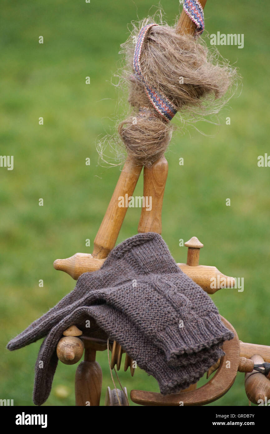 Spinning Wheel And Hand-Knitted Woolen Socks Stock Photo - Alamy