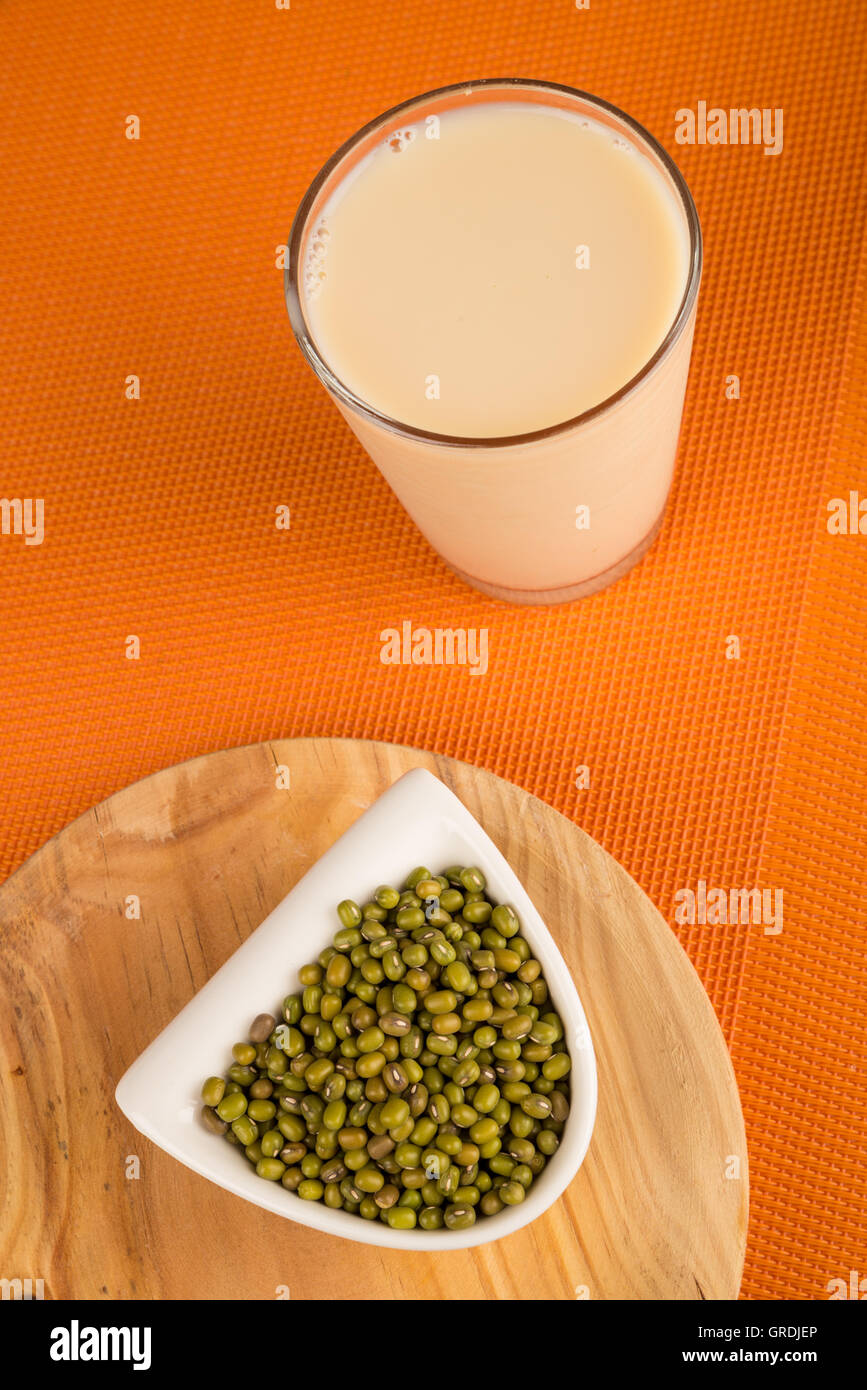 Glass of soy milk in a still life with raw beans Stock Photo - Alamy