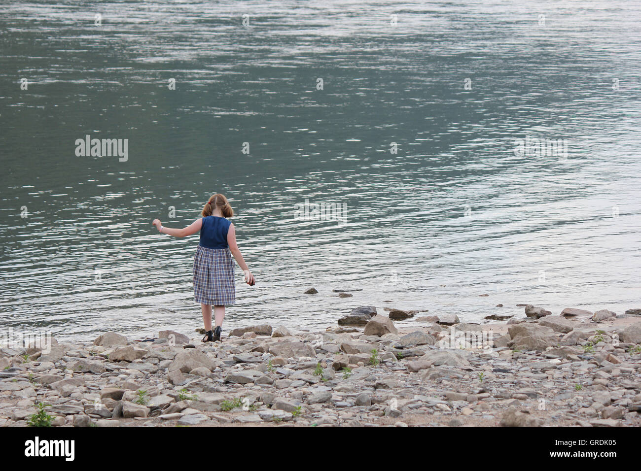 Girl throwing stones hi-res stock photography and images - Alamy