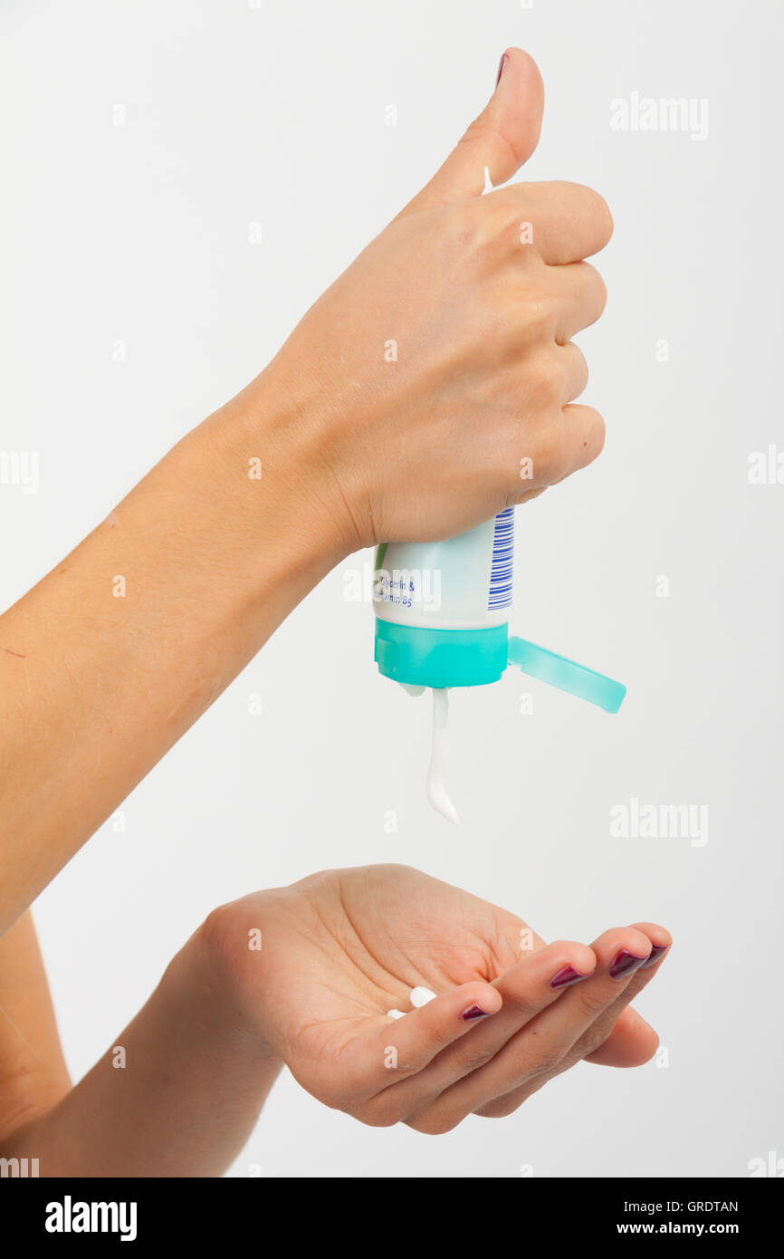 Woman Squeezes Hand Cream From A Tube In Her Hand Stock Photo - Alamy
