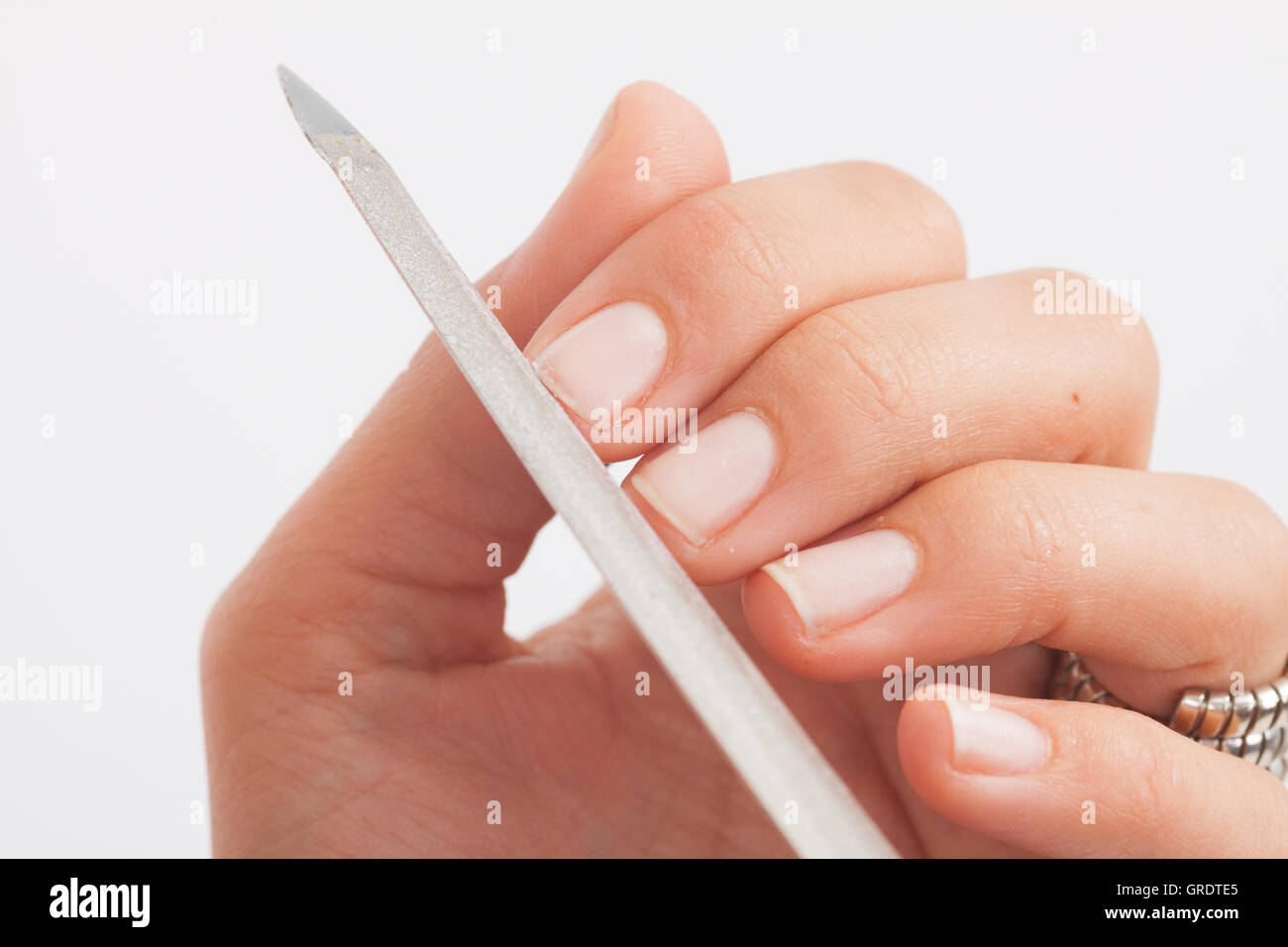 Hand Of A Young Woman Filing Nails Stock Photo - Alamy