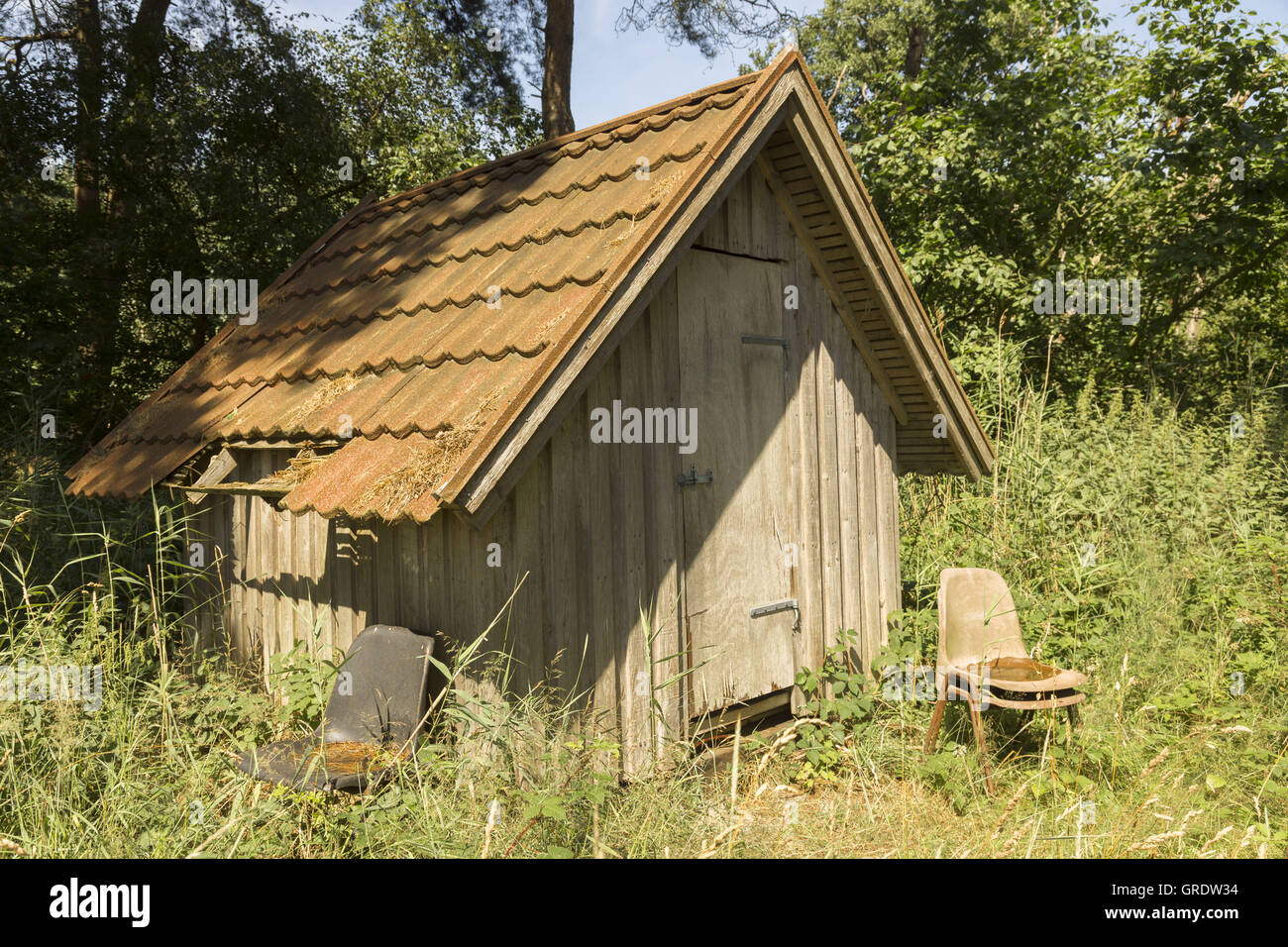 Small Decayed Hut With Chairs In Front Of It On The Brink Of A Path ...