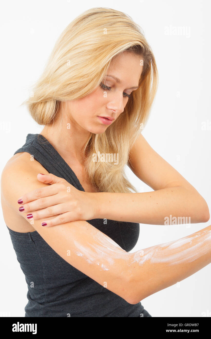 Woman Putting Lotion On Her Arm With White Ointment Stock Photo - Alamy