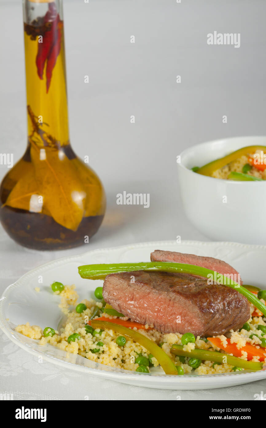 Roast Lamb On Rice With Carrots And Peas Stock Photo - Alamy