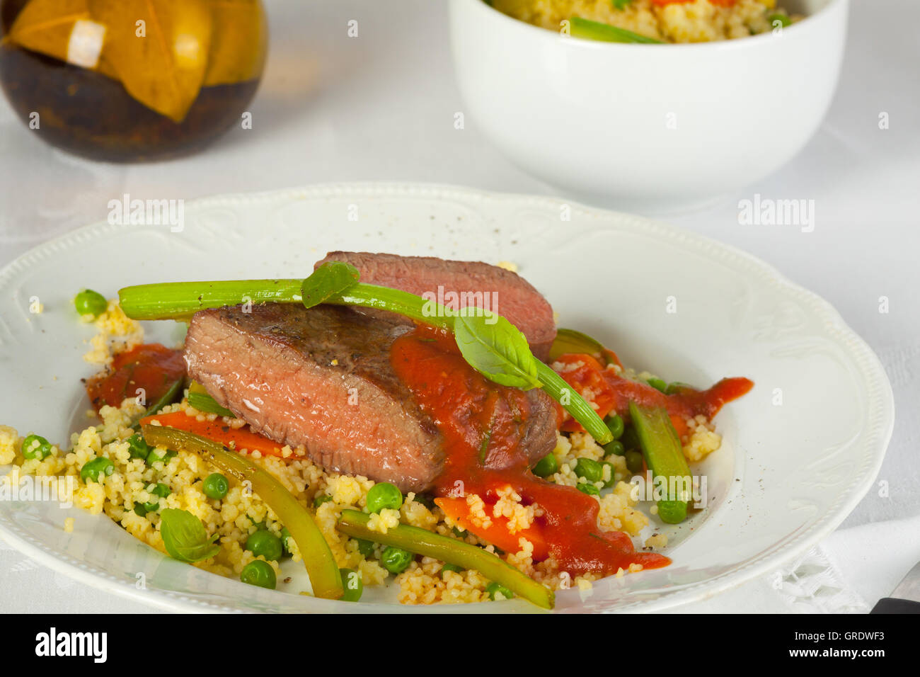 Roast Lamb On Rice With Carrots And Peas Stock Photo - Alamy