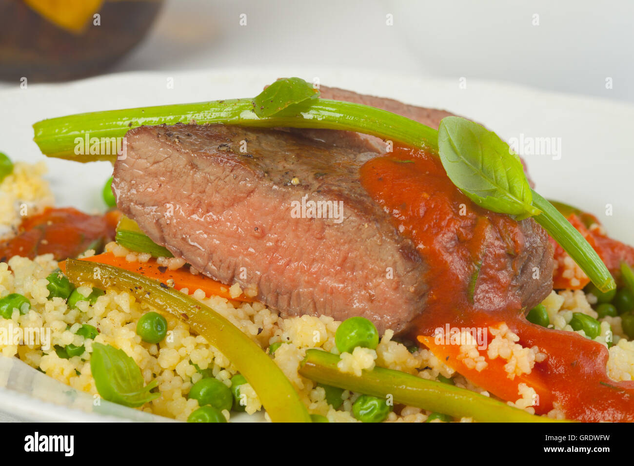 Roast Lamb On Rice With Carrots And Peas Stock Photo - Alamy