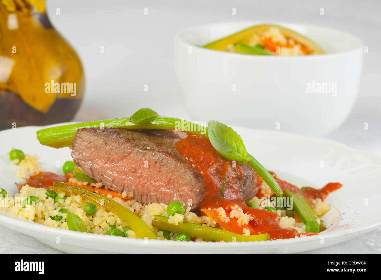 Roast Lamb On Rice With Carrots And Peas Stock Photo - Alamy