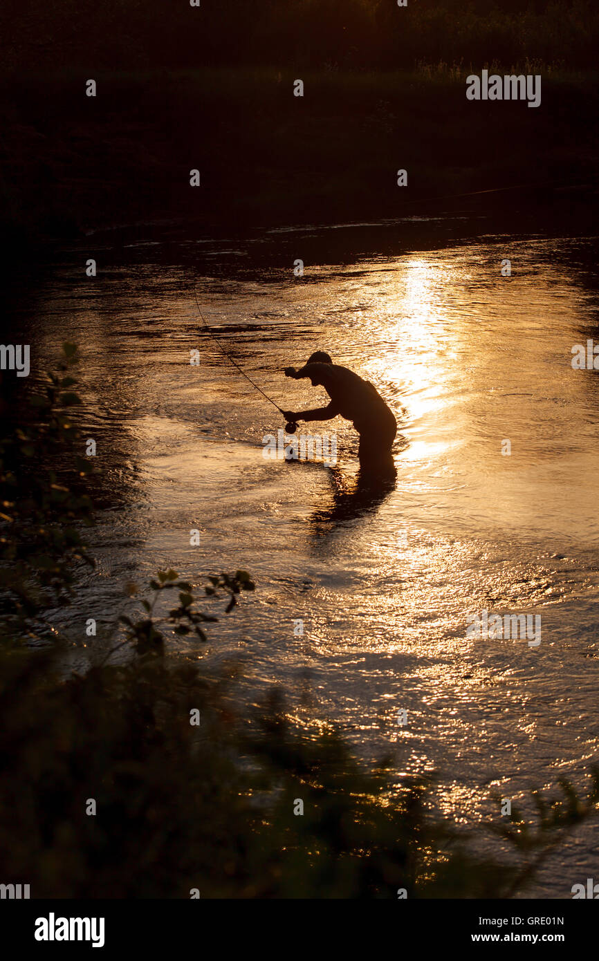Black man catching fish hi-res stock photography and images - Alamy